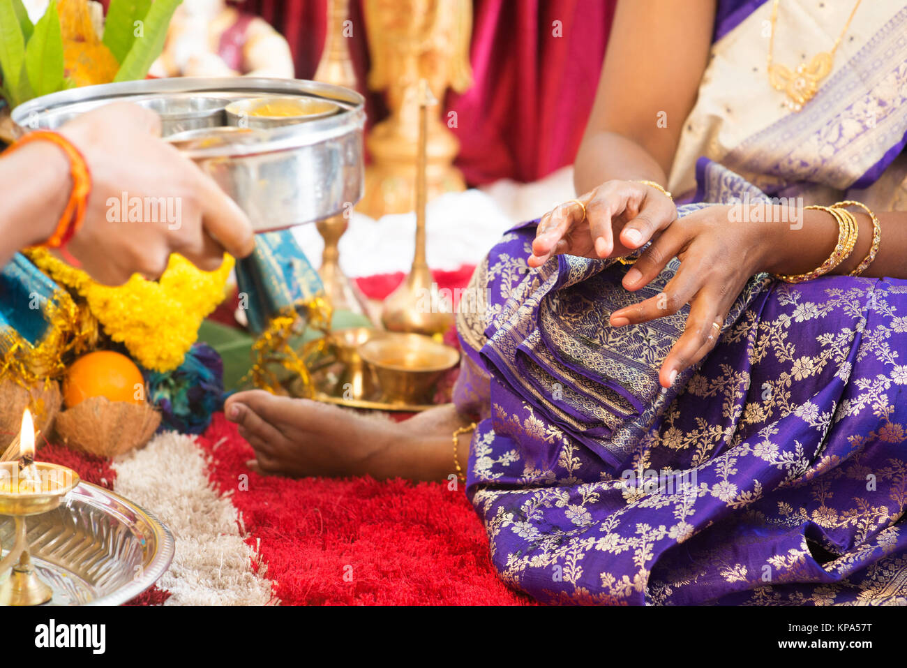 Indian woman received prayers from priest Stock Photo - Alamy