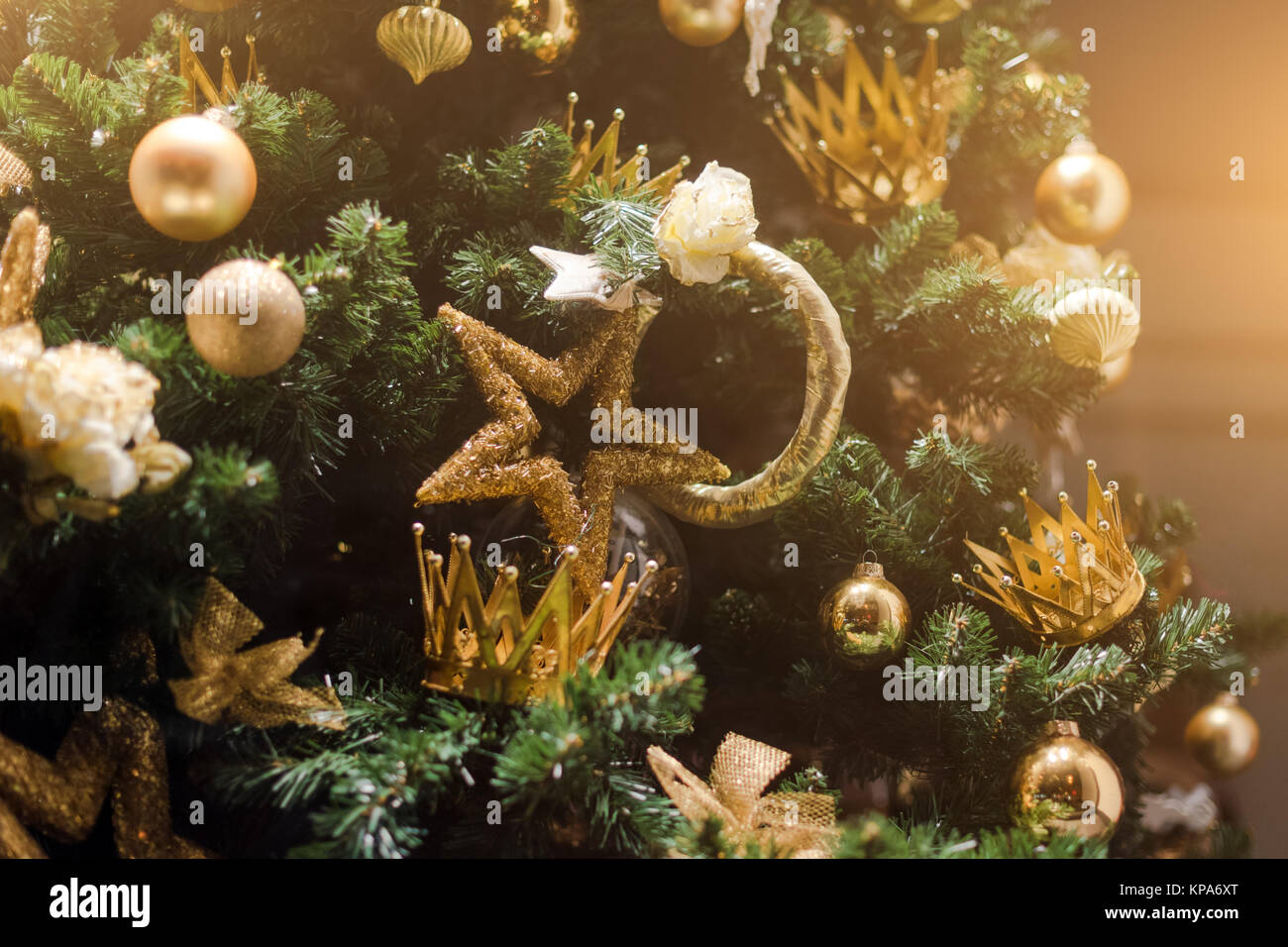 Christmas tree decorated with golden stars and crowns Stock Photo - Alamy