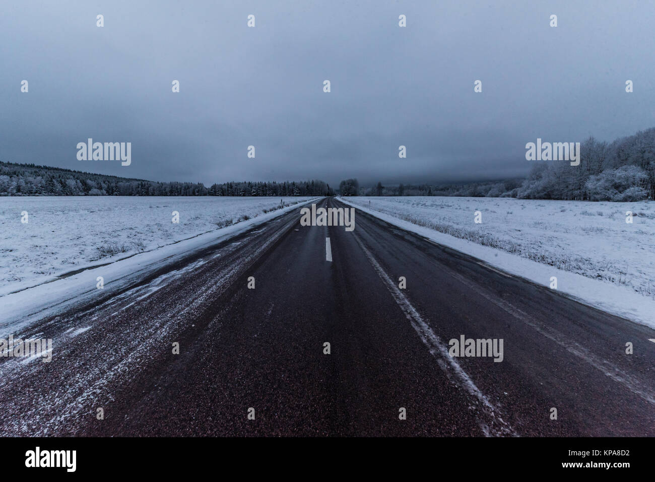 Strait road with snowy fields on both sides Stock Photo - Alamy