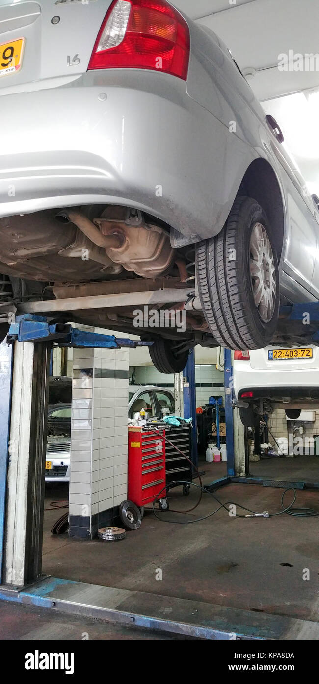 Car being serviced in a garage Stock Photo - Alamy