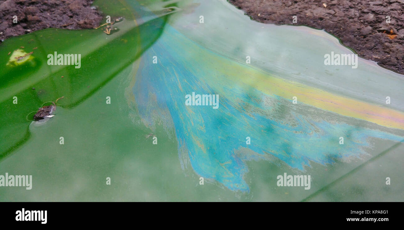 Oil Spill rainbow colors on tarmac Stock Photo - Alamy