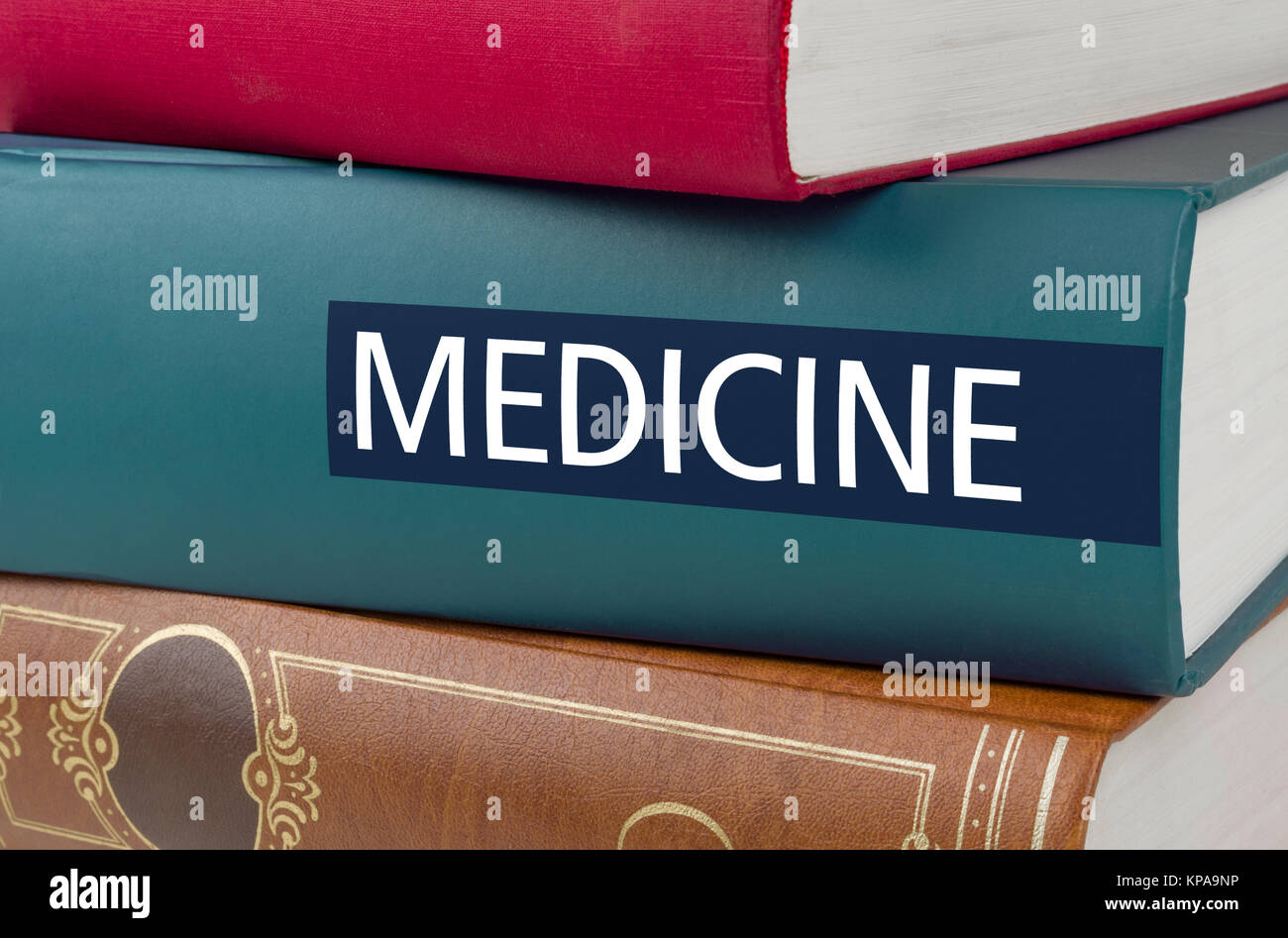 A book with the title Medicine written on the spine Stock Photo - Alamy
