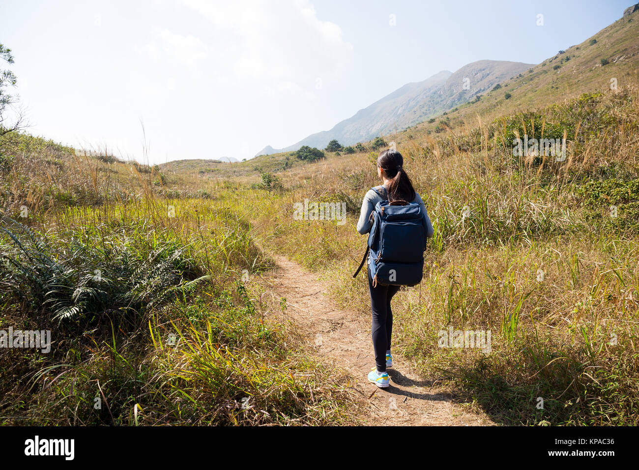 Back view of woman go hiking Stock Photo - Alamy