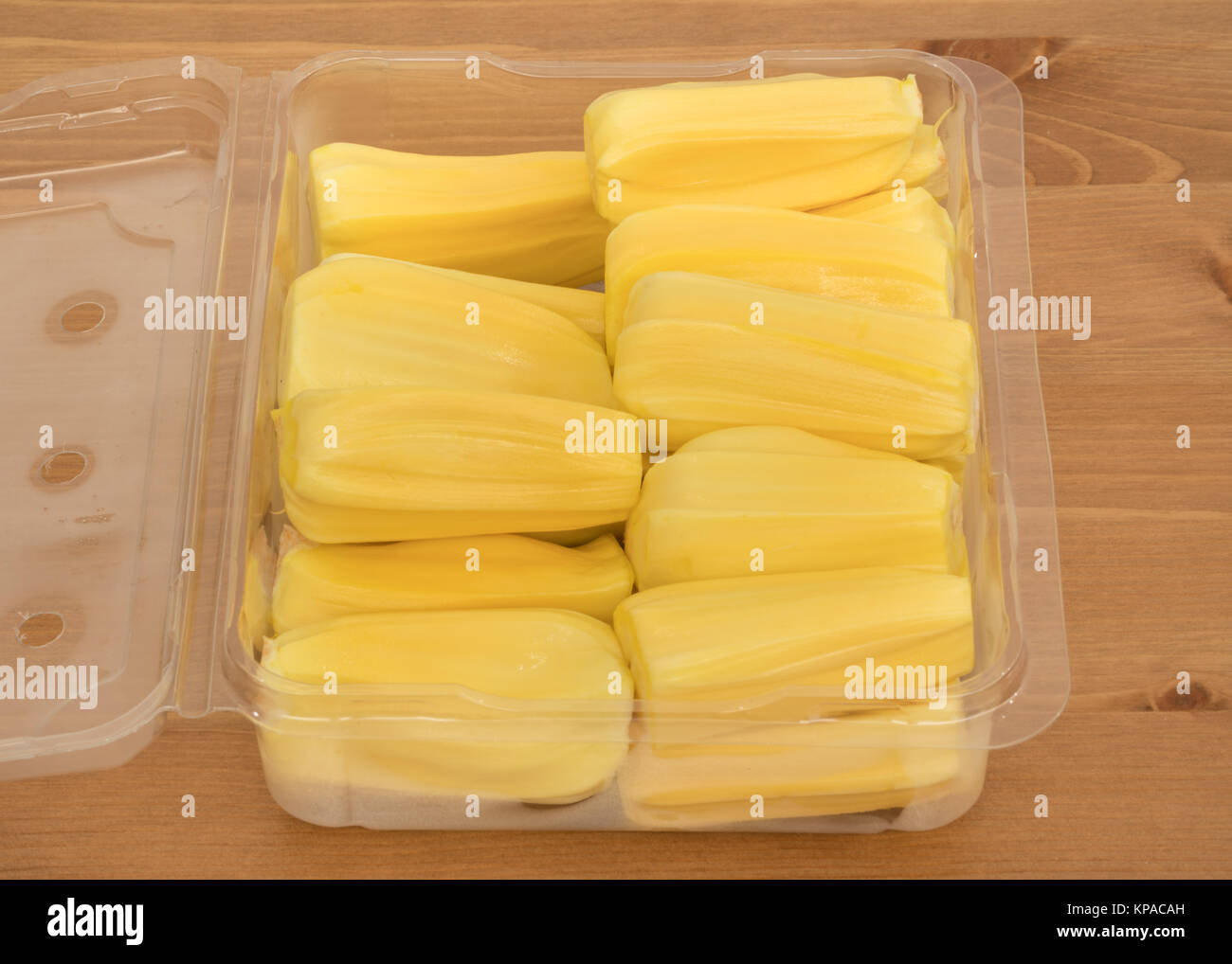 Box of Yellow Jackfruit flesh isolated on wooden background Stock Photo ...