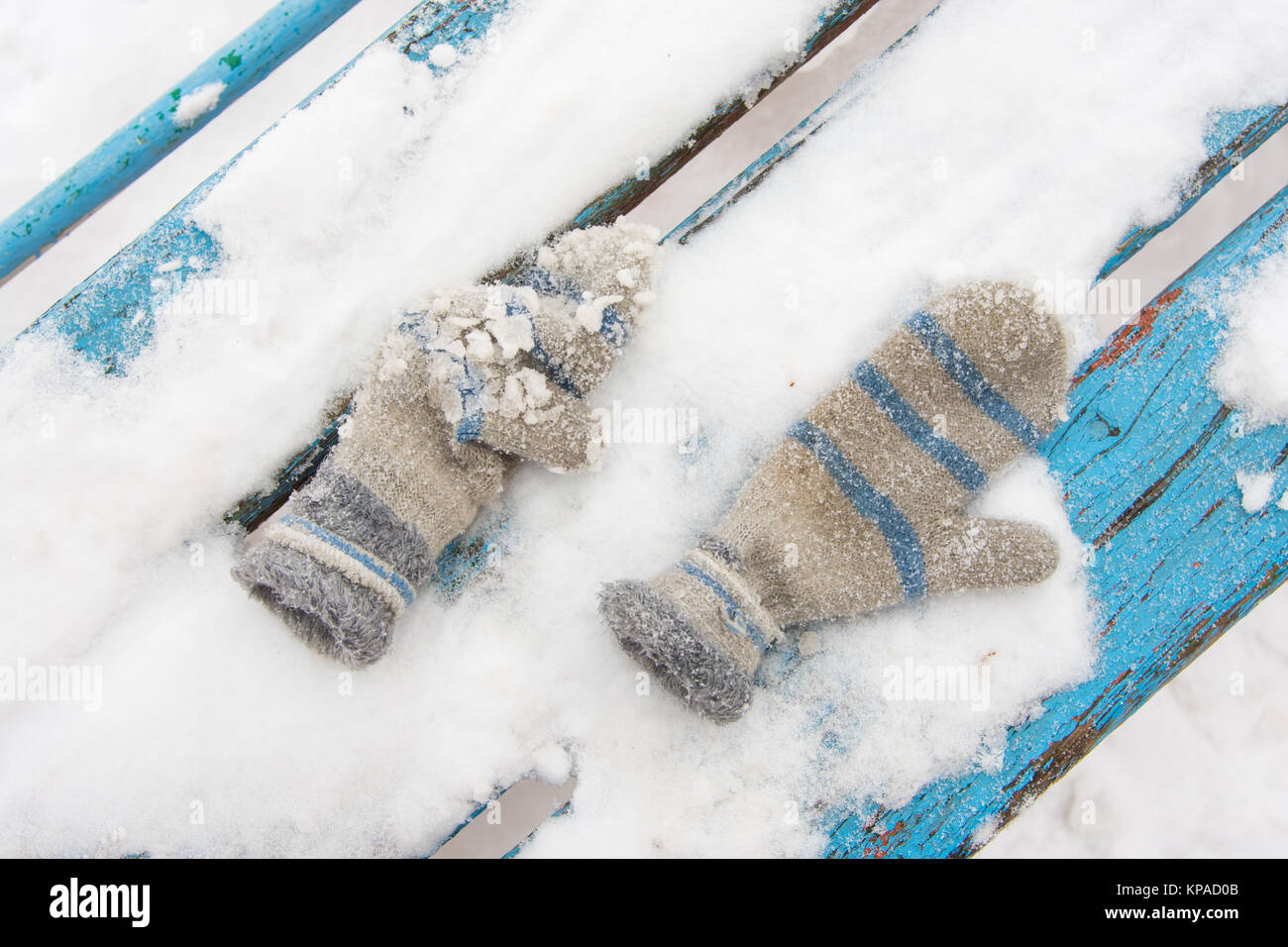 On a snow-covered bench are children mittens forgotten child Stock ...