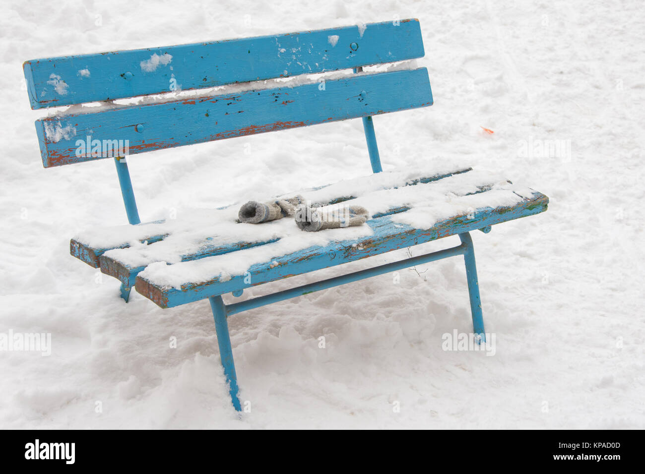 On a snow-covered bench lie forgotten childrens mittens Stock Photo - Alamy