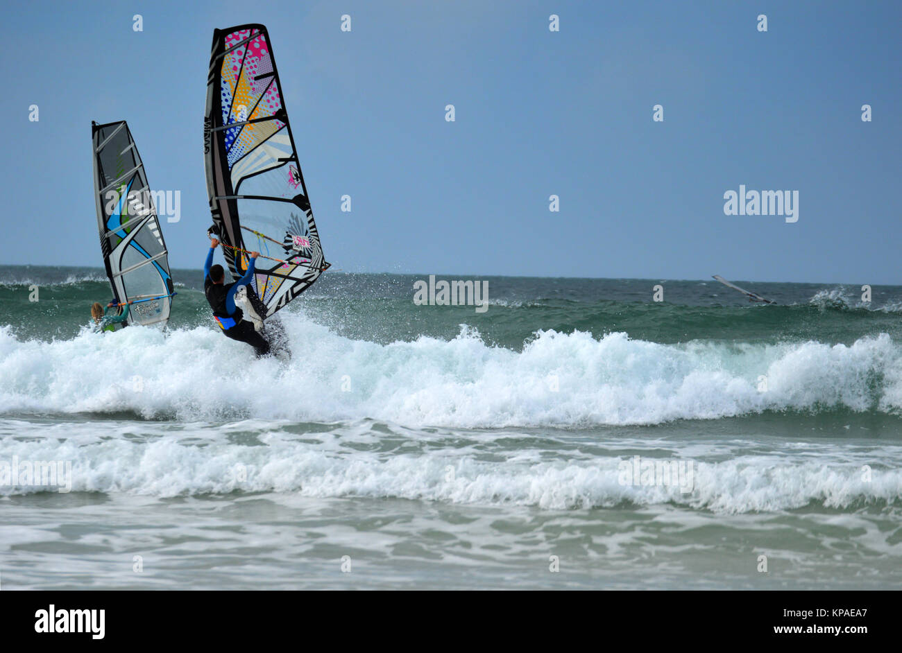 Men windsurfing waves in Gwithian, Cornwall, UK Stock Photo - Alamy
