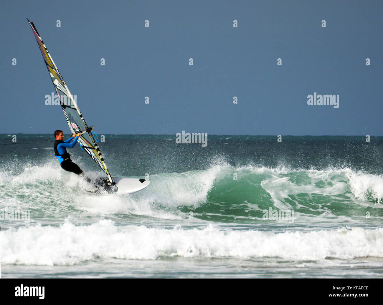 Man windsurfing waves in Gwithian, Cornwall, UK Stock Photo - Alamy