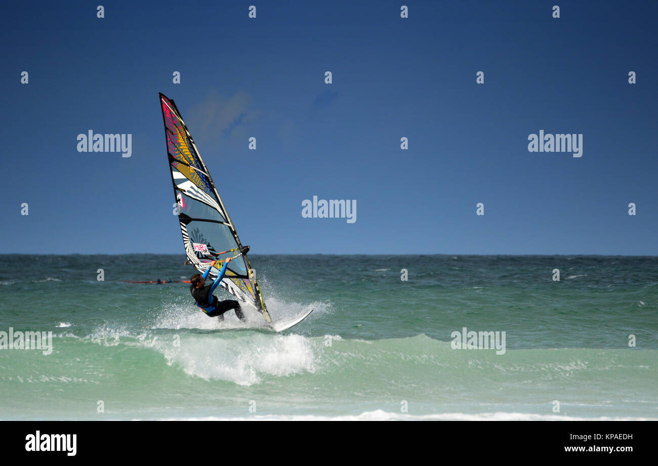 Man windsurfing waves in Gwithian, Cornwall, UK Stock Photo - Alamy