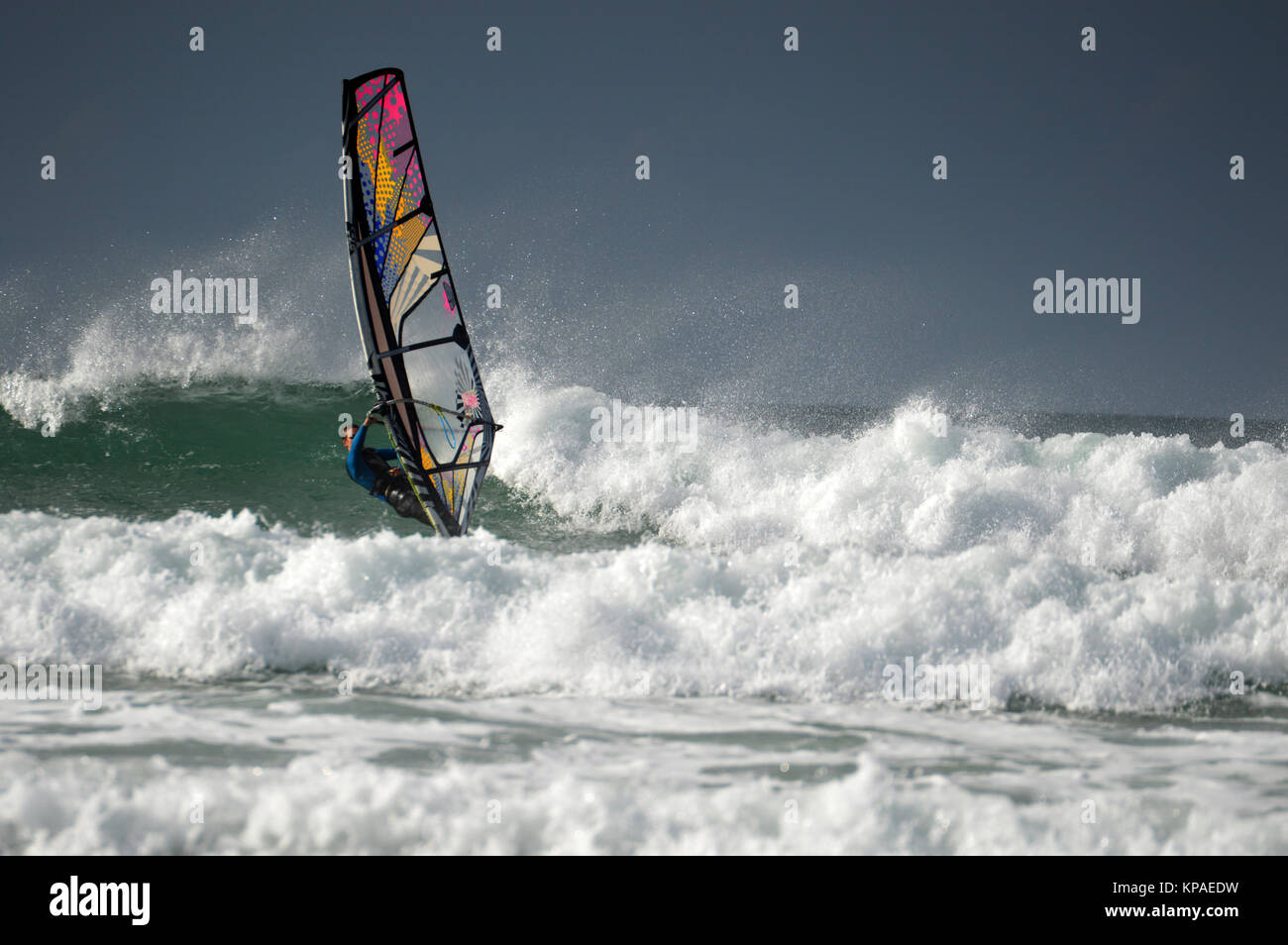Man windsurfing waves in Gwithian, Cornwall, UK Stock Photo - Alamy