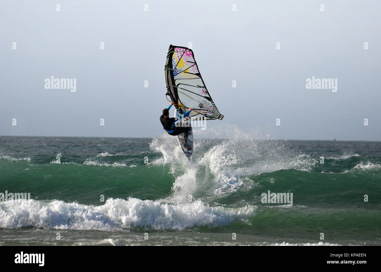 Man windsurfing waves in Gwithian, Cornwall, UK Stock Photo - Alamy