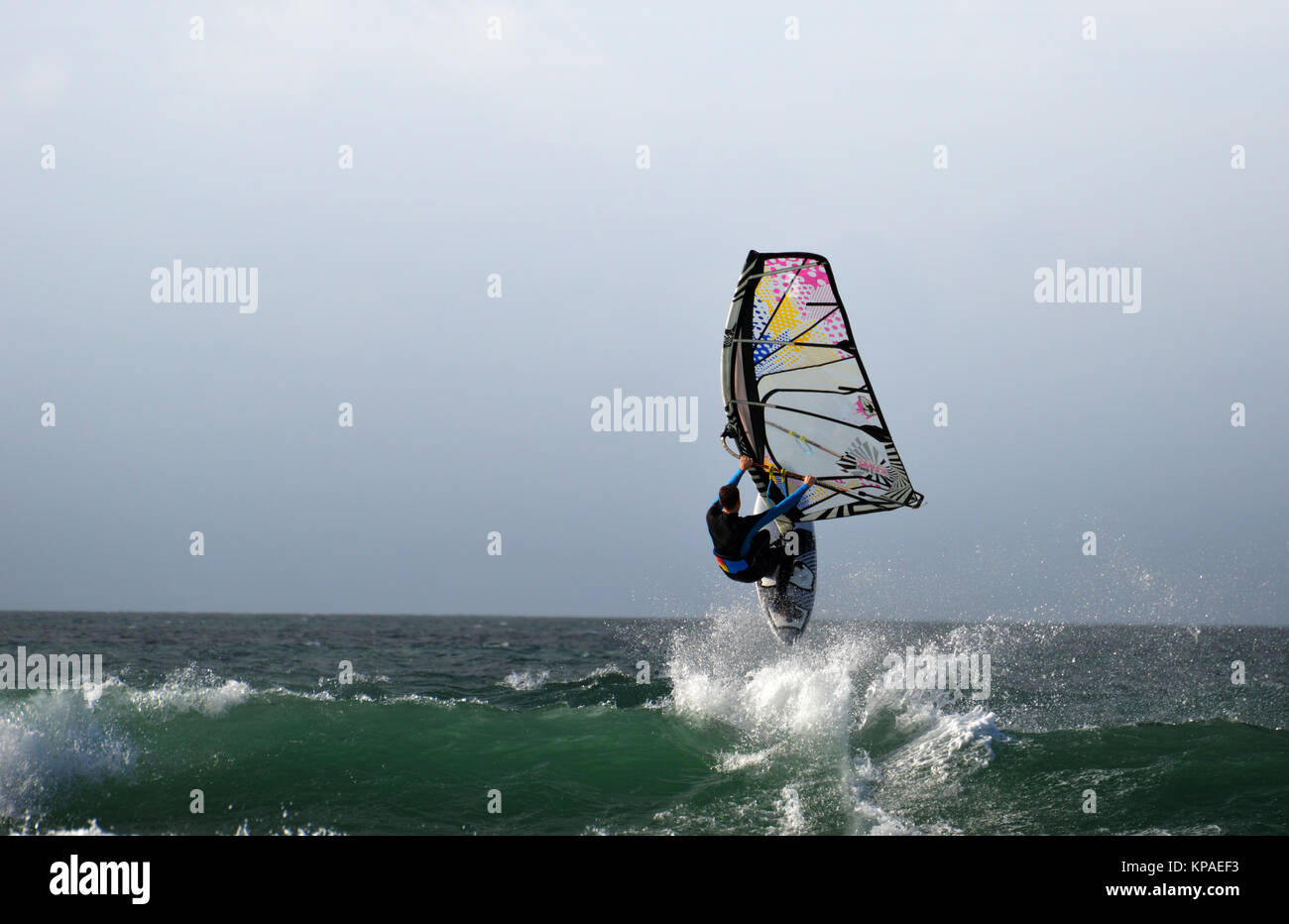 Man windsurfing waves in Gwithian, Cornwall, UK Stock Photo - Alamy