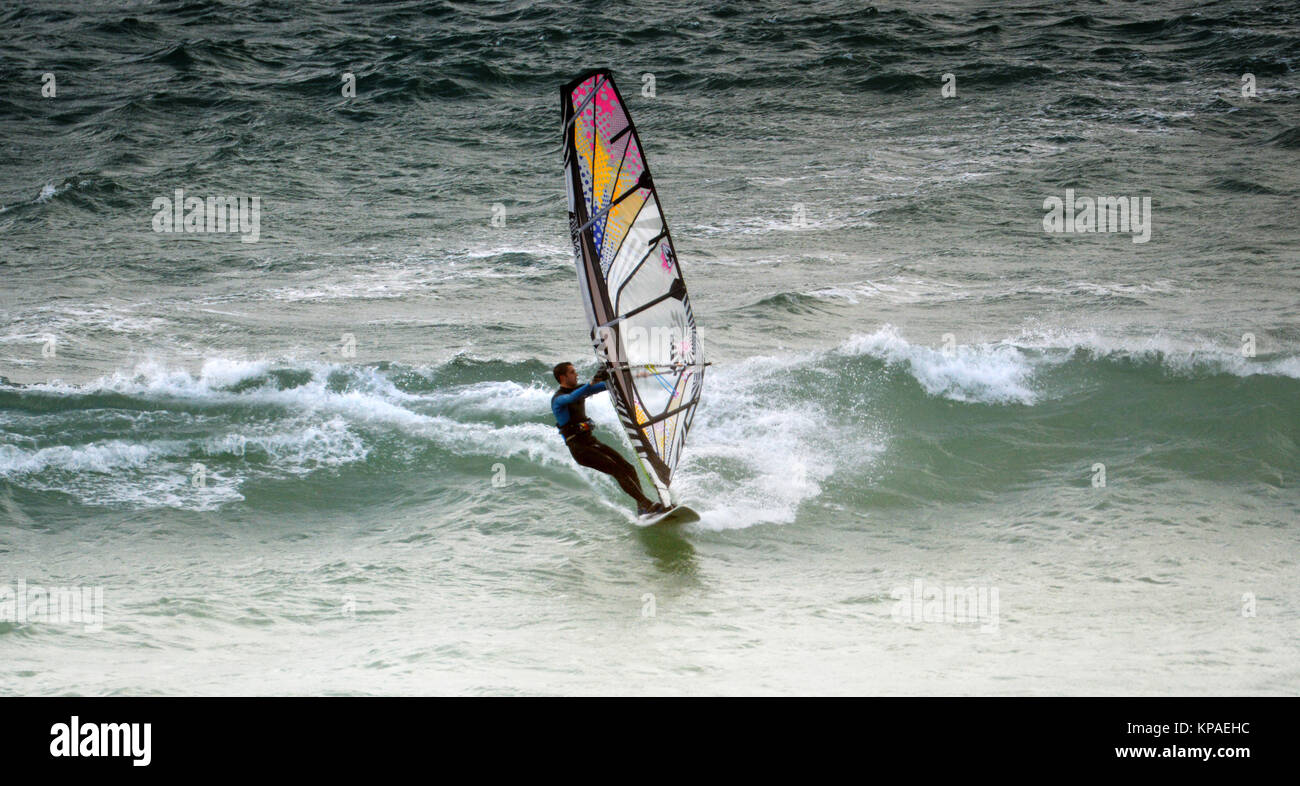 Man windsurfing waves in Gwithian, Cornwall, UK Stock Photo - Alamy