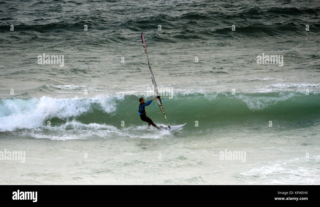 Man windsurfing waves in Gwithian, Cornwall, UK Stock Photo - Alamy