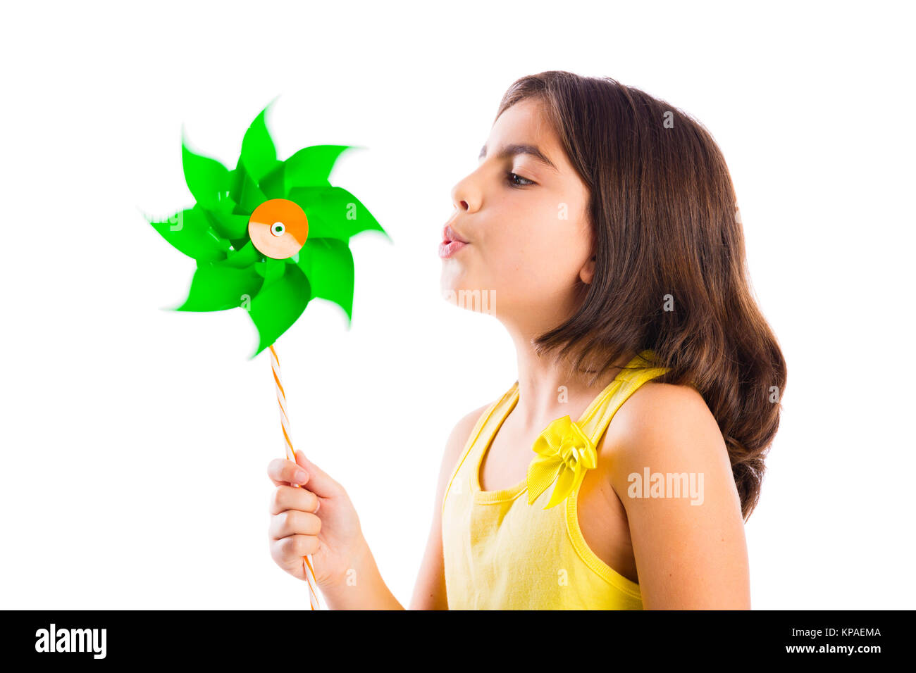 Girl blowing a windmill Stock Photo - Alamy