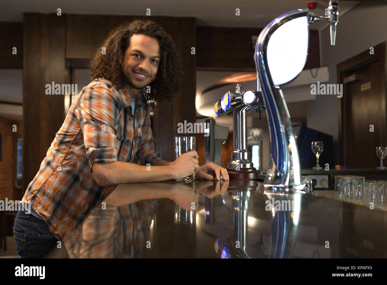 Young man at a bar Stock Photo - Alamy