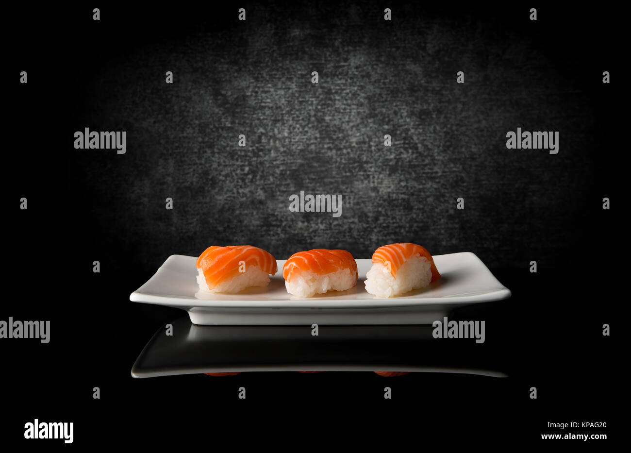 Three sushi on black Stock Photo - Alamy