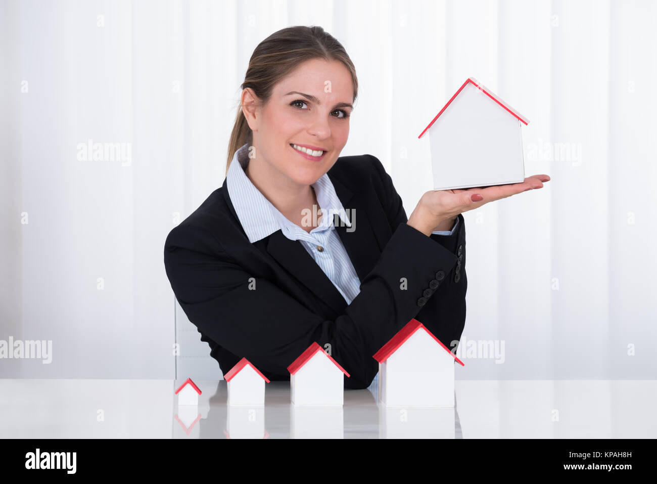 Businesswoman With House Models Stock Photo - Alamy