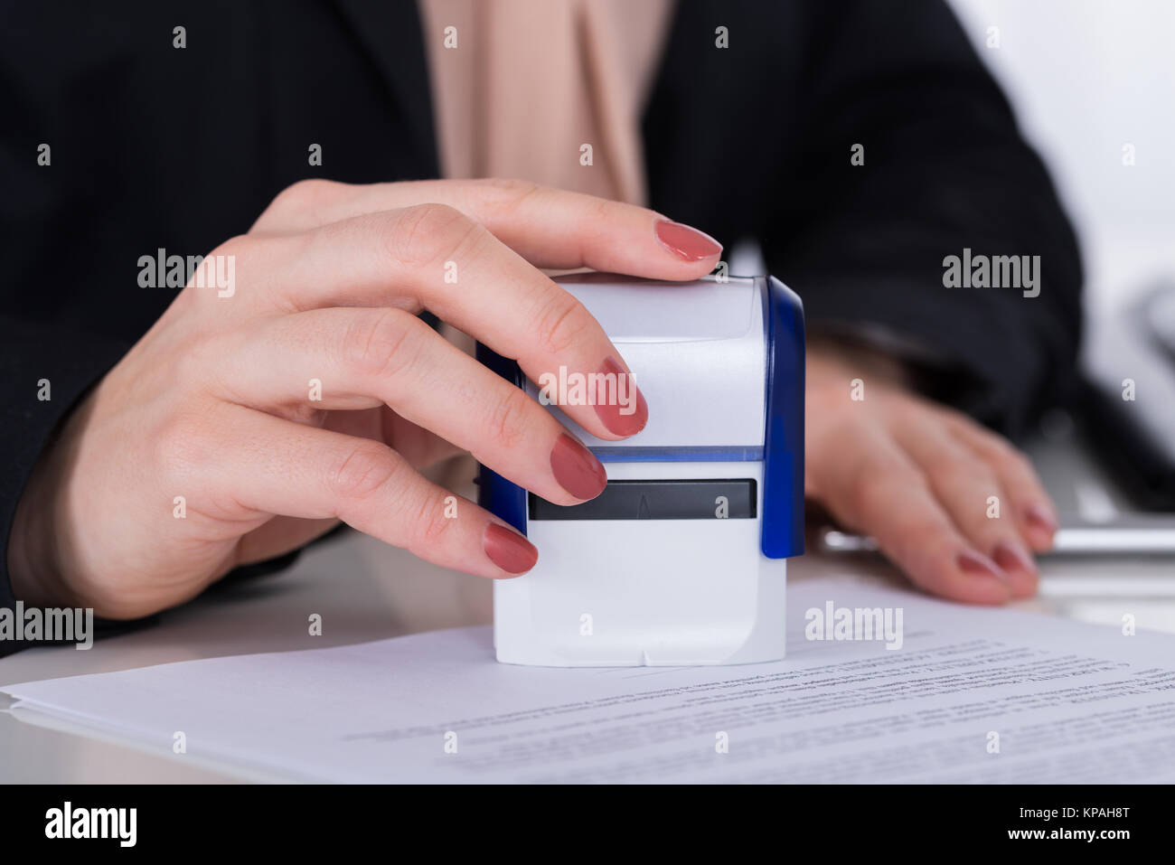 Businessperson Using Stamper On Document Stock Photo - Alamy