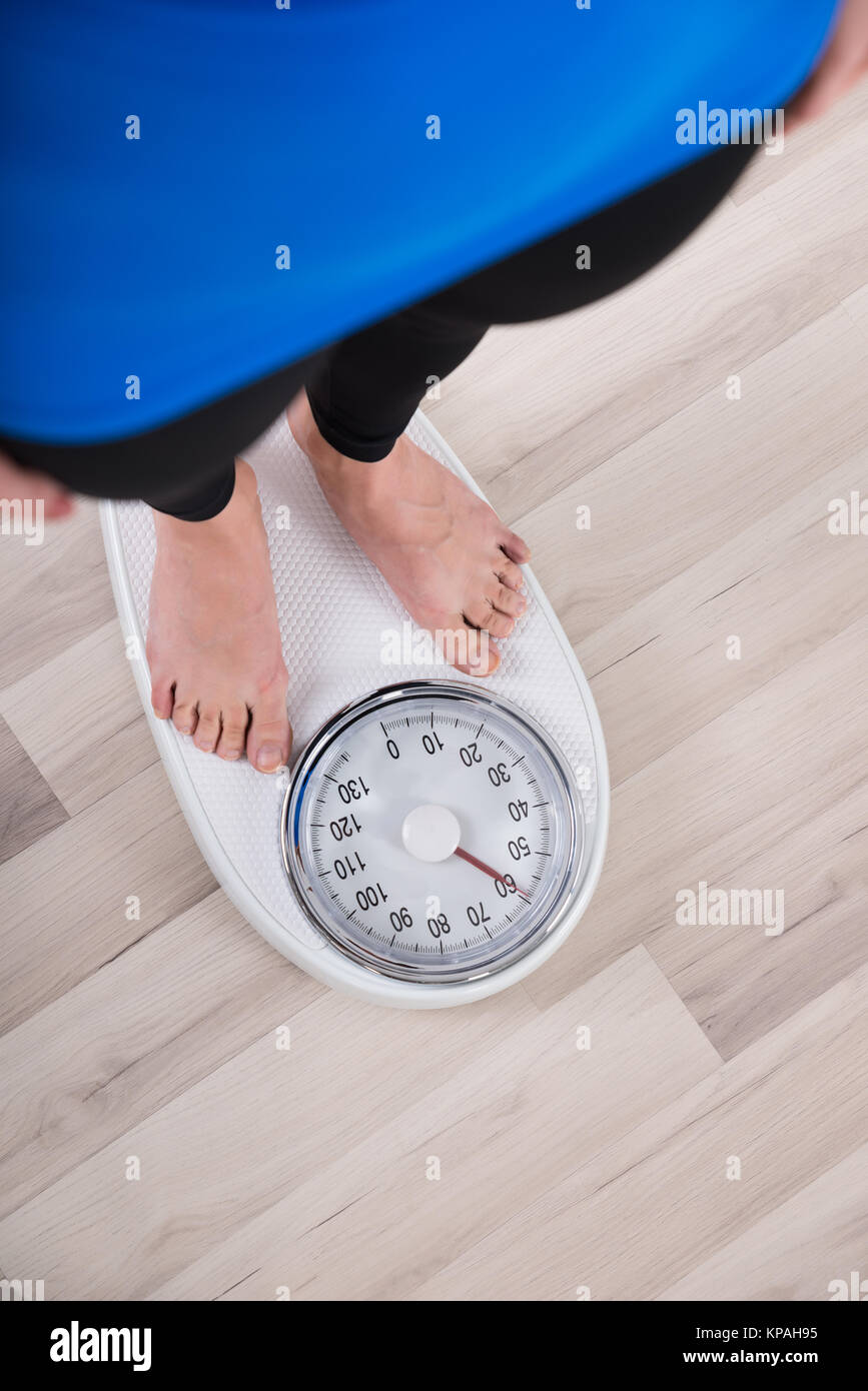 Woman Measuring Weight On Weighing Scale Stock Photo - Alamy