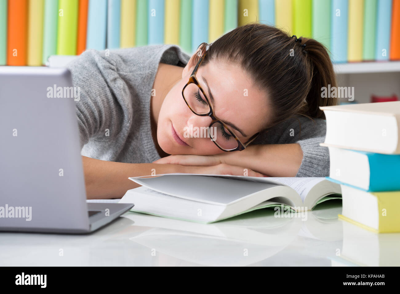 Woman Sleeping In Library Stock Photo - Alamy