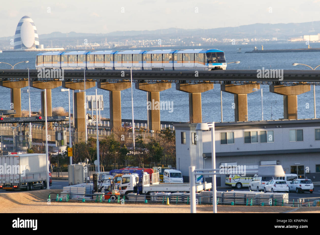 Tokyo Monorail train moves along an elevated track between Haneda ...