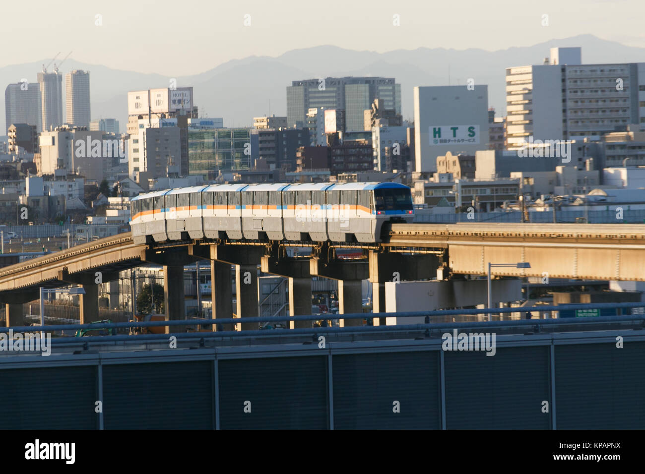 Tokyo Monorail train moves along an elevated track between Haneda ...