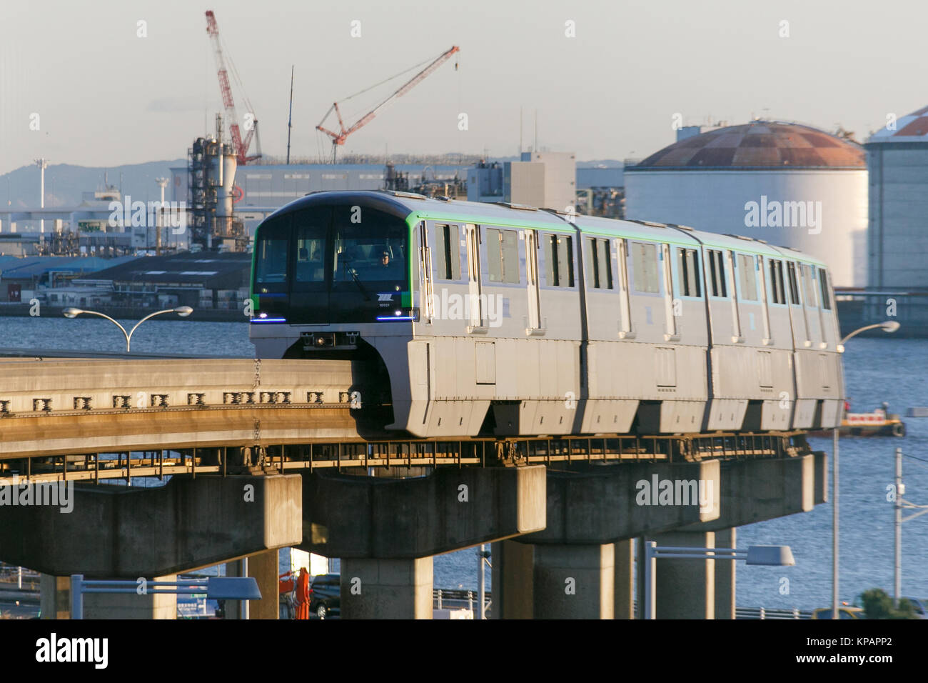 Tokyo Monorail train moves along an elevated track between Haneda ...
