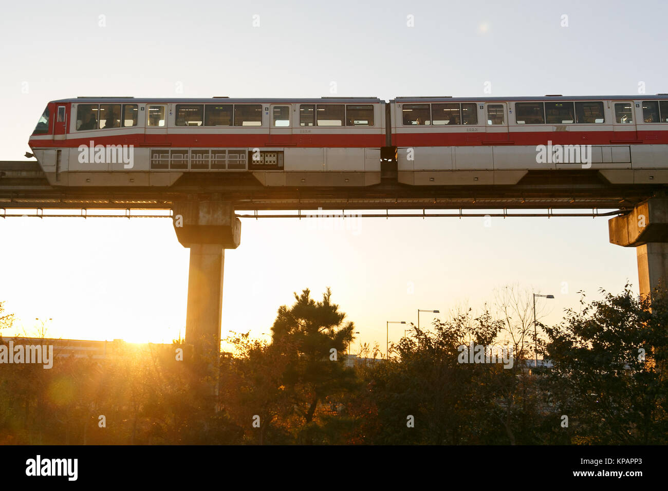 Tokyo Monorail train moves along an elevated track between Haneda ...