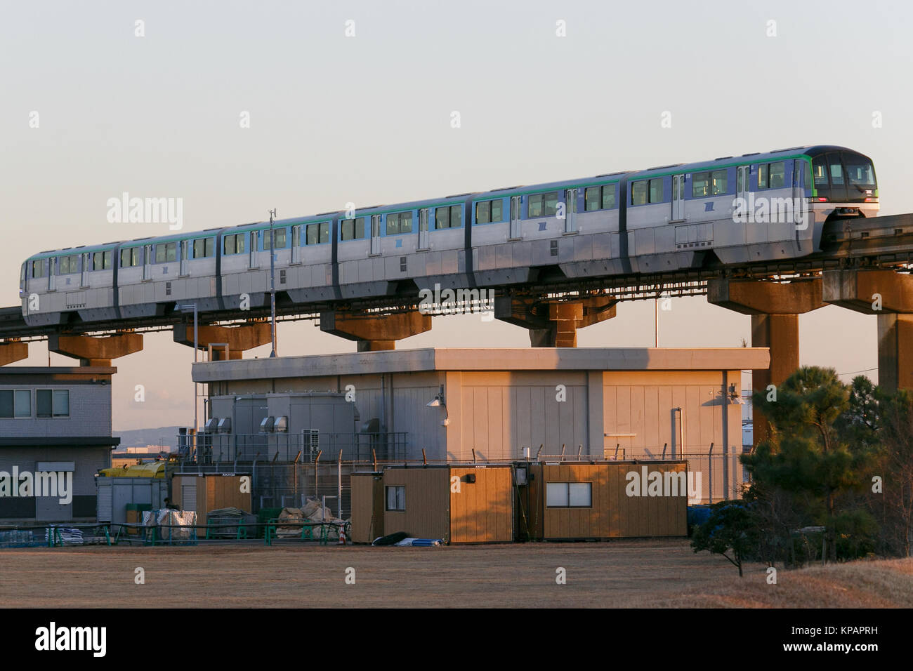 Tokyo Monorail train moves along an elevated track between Haneda ...