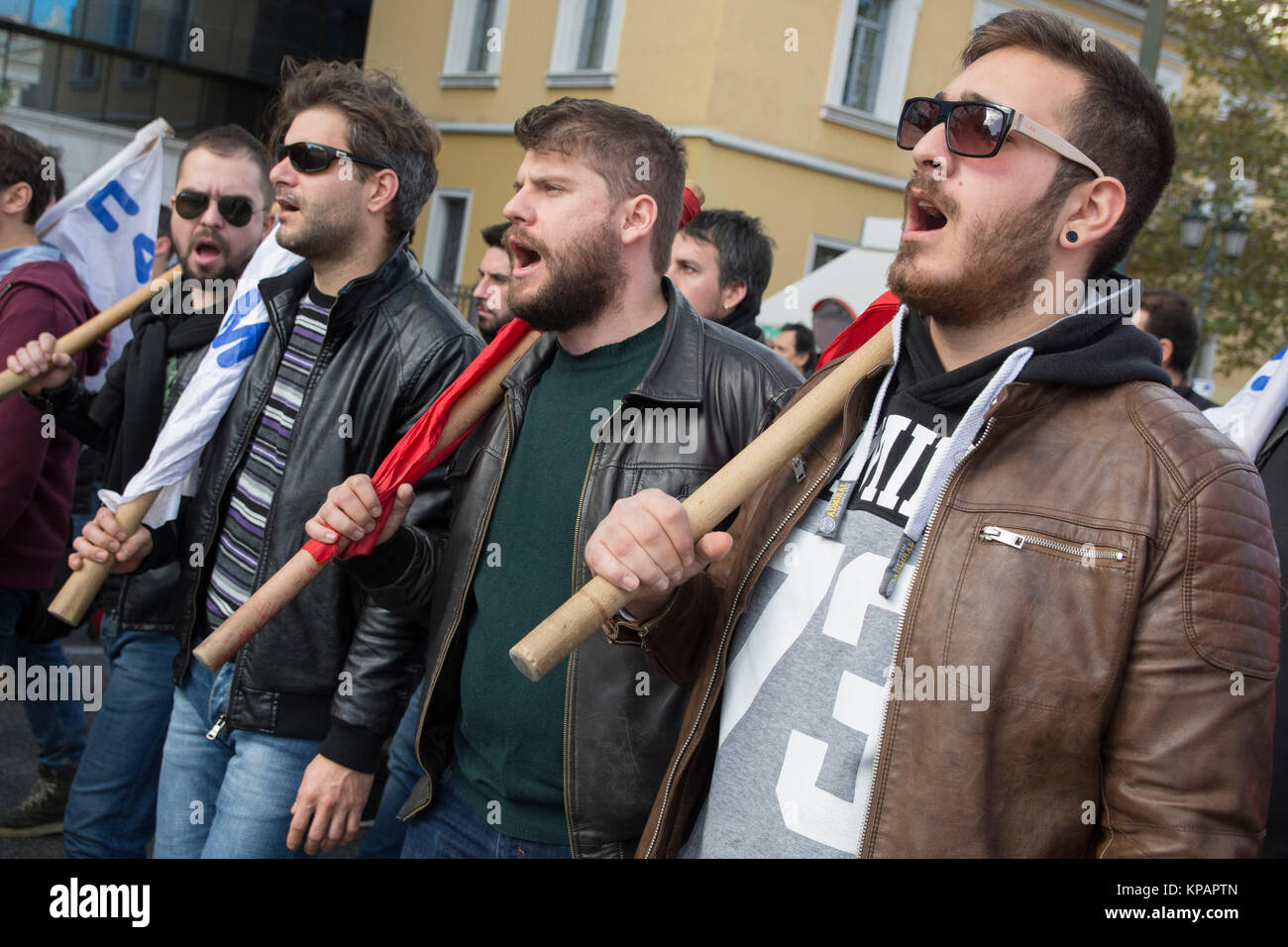 Strikers march holding banners and shouting slogans defending the right ...
