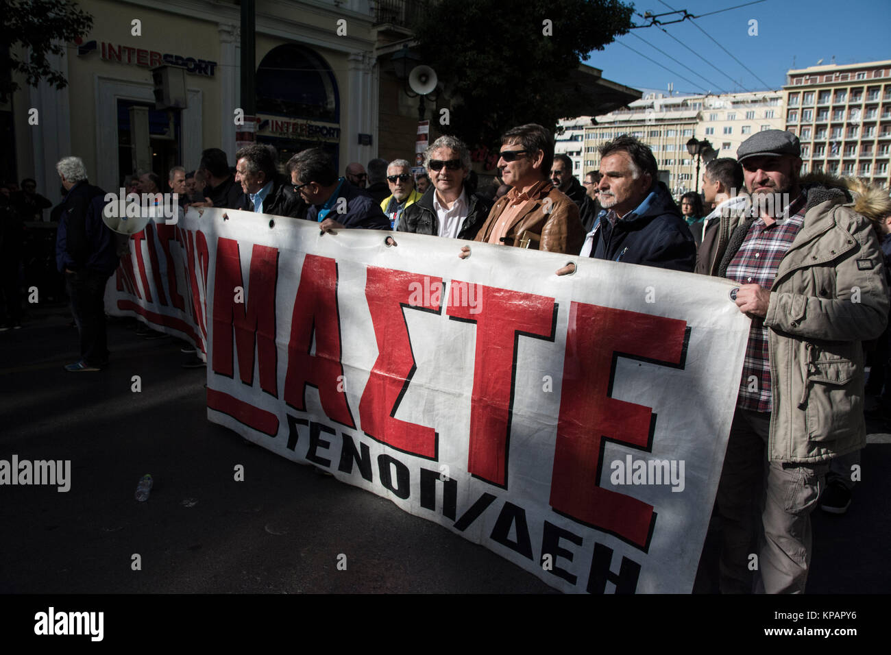 Strikers march holding banners and shouting slogans defending the right ...