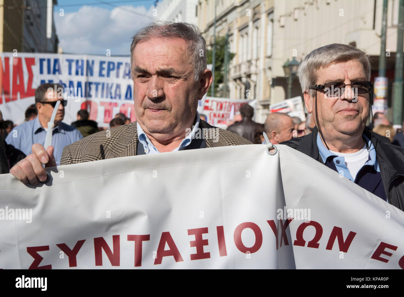 Strikers march holding banners and shouting slogans defending the right ...