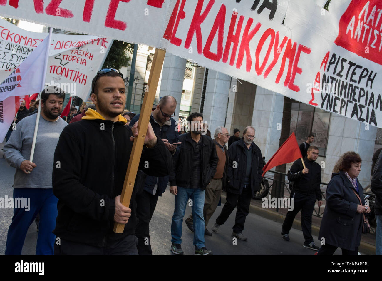Strikers march holding banners and shouting slogans defending the right ...