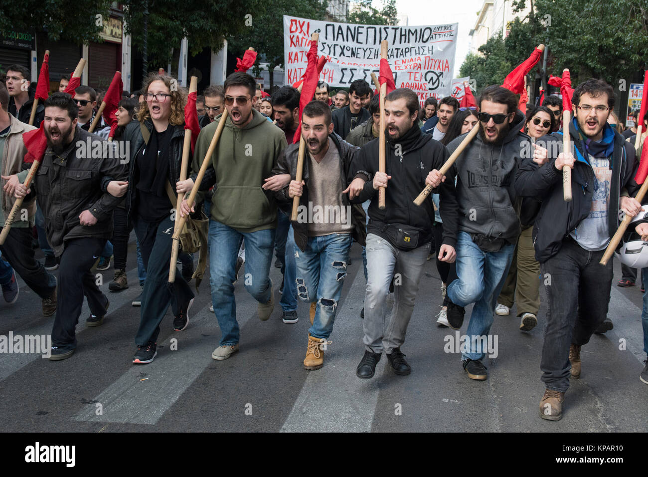 Strikers march holding banners and shouting slogans defending the right ...
