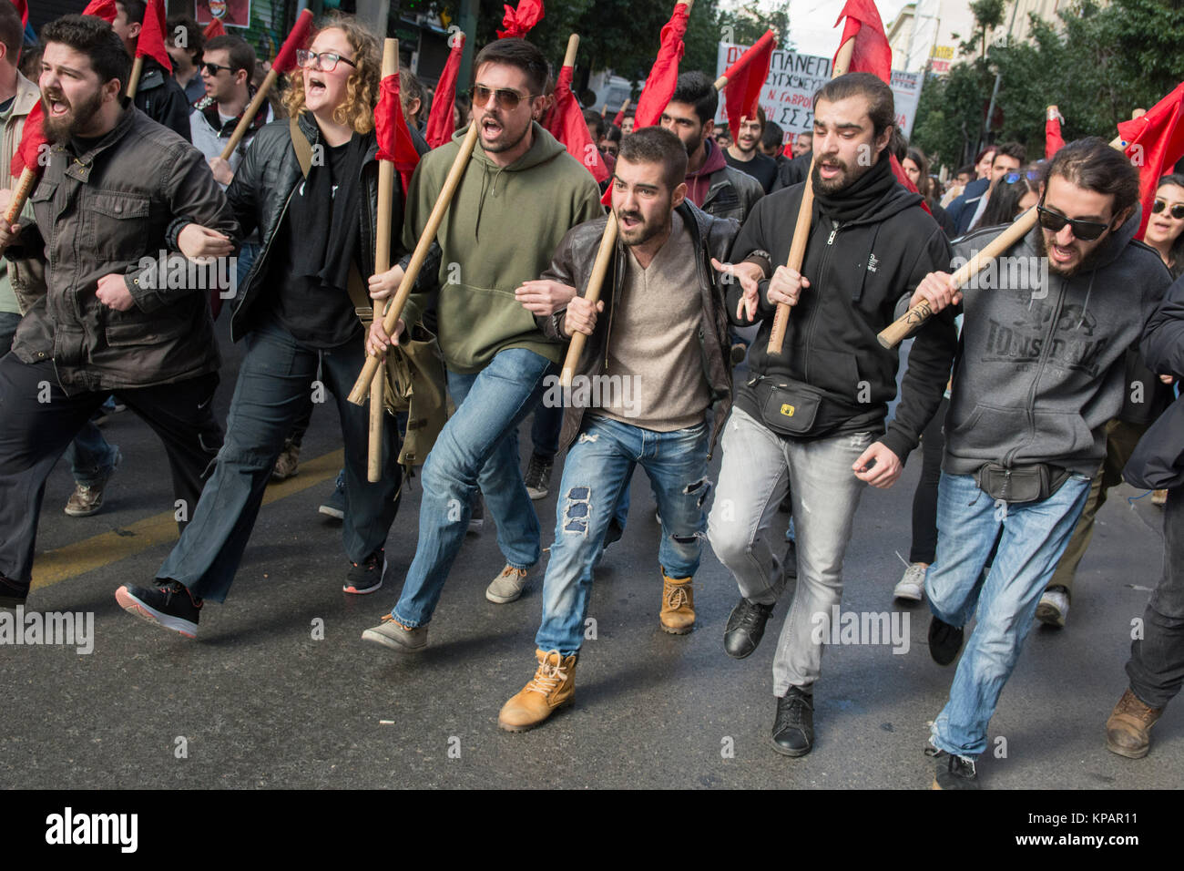 Strikers march holding banners and shouting slogans defending the right ...