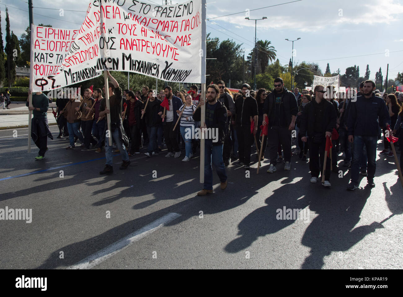 Strikers march holding banners and shouting slogans defending the right ...