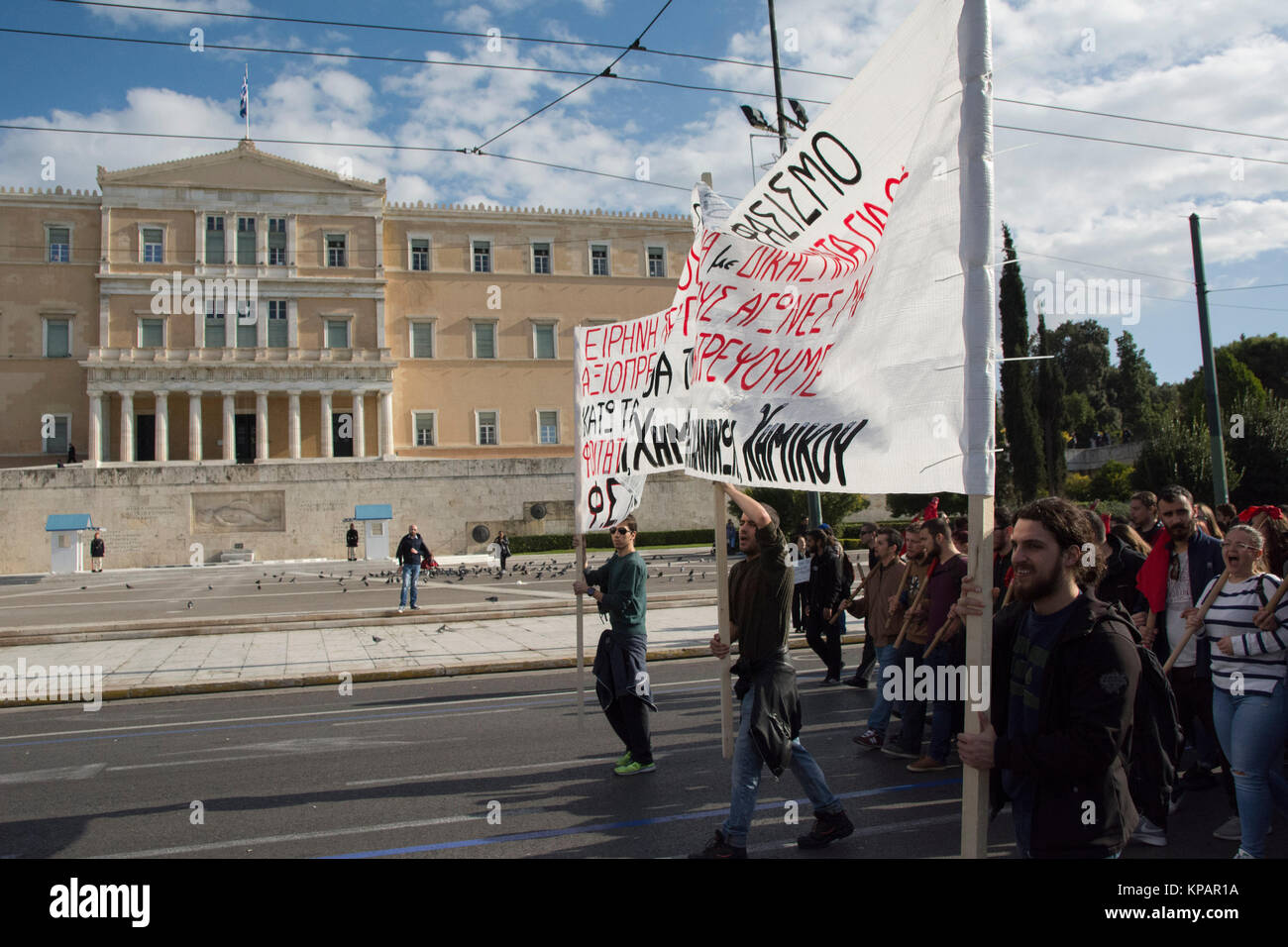 Strikers march holding banners and shouting slogans defending the right ...