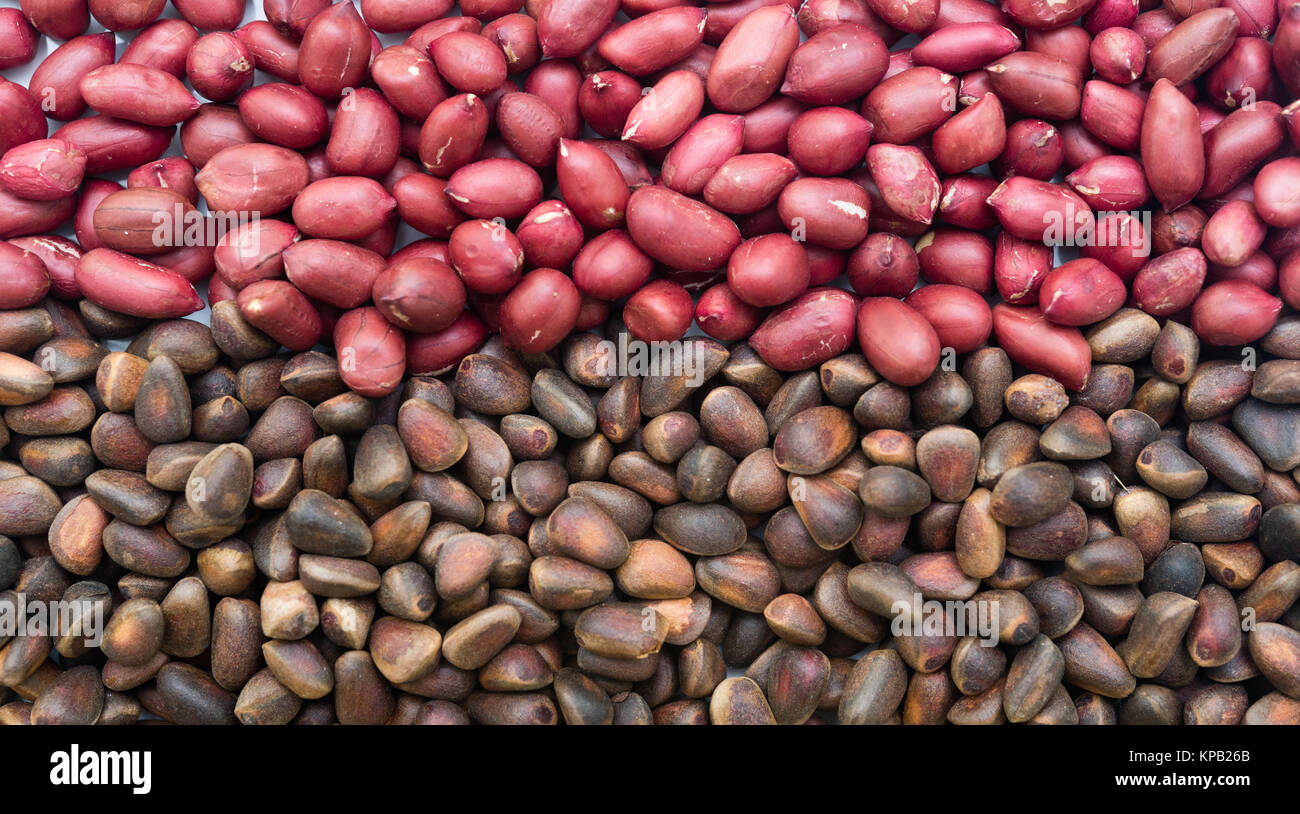 peanuts and pine nuts as a background Stock Photo - Alamy