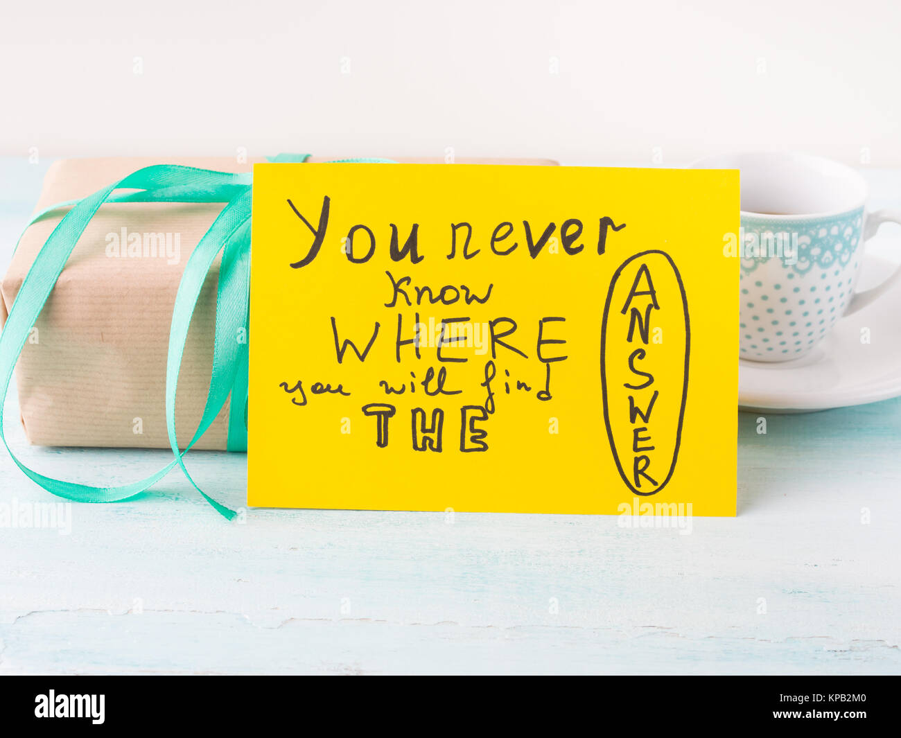 Wrapped surprise birthday holiday gift box with green ribbon and cup ...