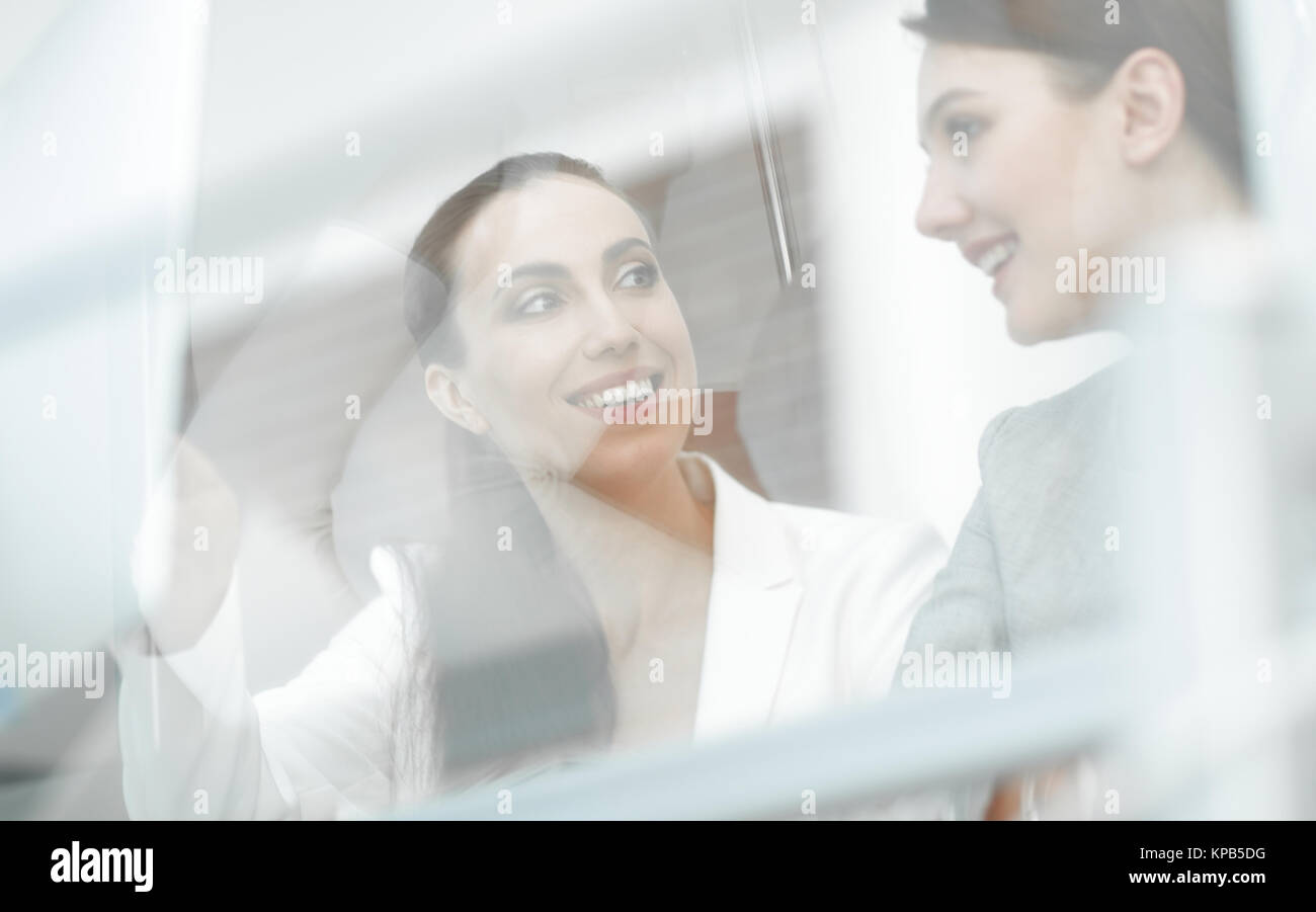 behind the glass.colleagues sitting at your Desk Stock Photo - Alamy