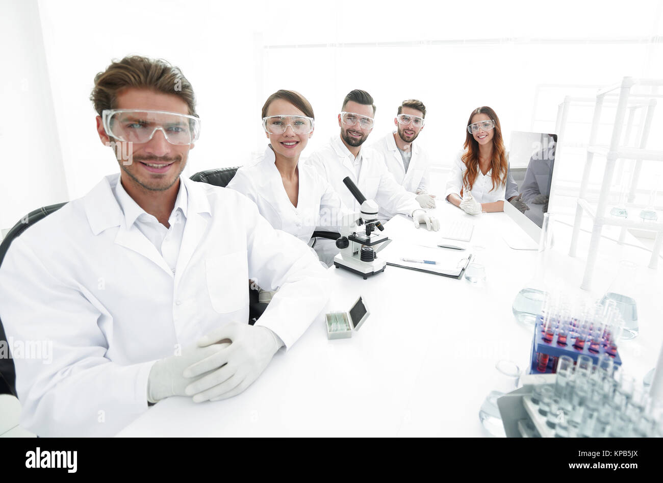 Male scientist and the team in the lab Stock Photo - Alamy