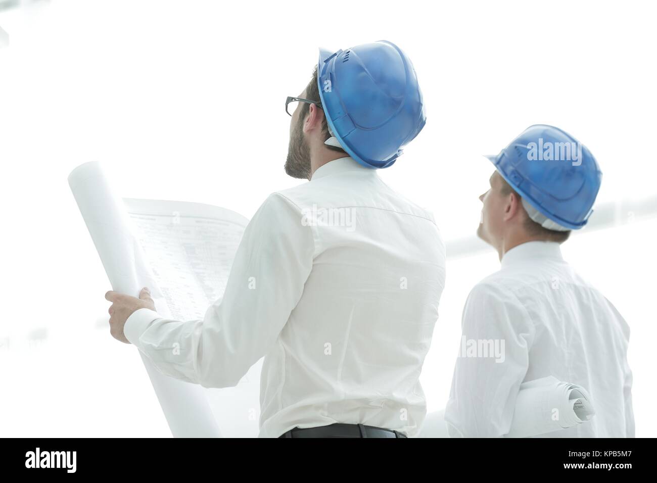 rear view.architect and Builder looking at blank screen Stock Photo - Alamy