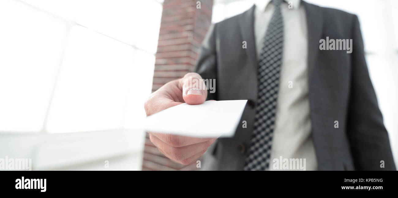 Businessman giving a card. Close-up photo in loft office Stock Photo ...