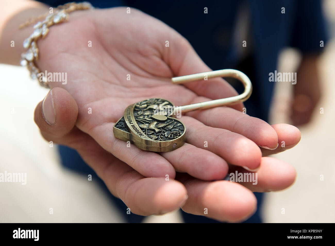 Close up image of hands holding wedding padlock Stock Photo - Alamy