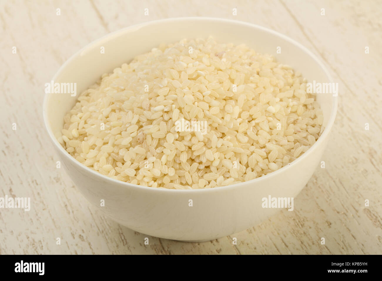 Raw rice heap in the bowl - ready for cooking Stock Photo - Alamy