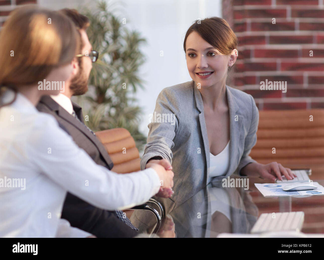 business woman greets the employee with a handshake Stock Photo - Alamy