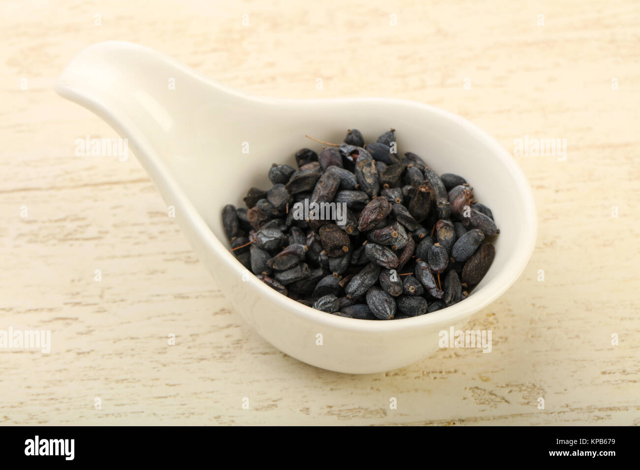 Dry barberry in the bowl over wooden background Stock Photo - Alamy