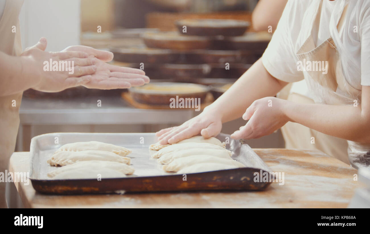 Bakery baker hands forming hi-res stock photography and images - Alamy