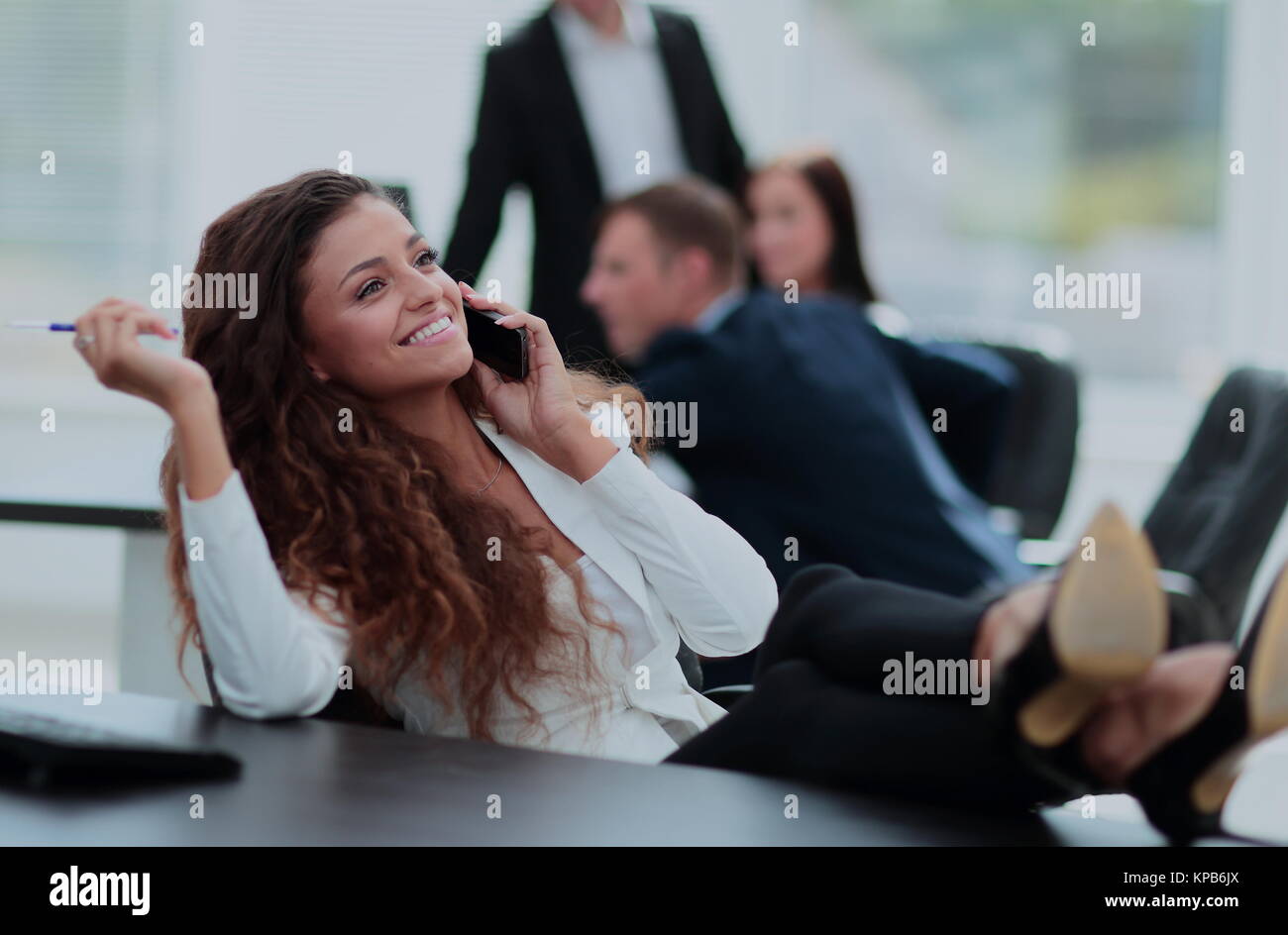 close up of a girl clerk in the workplace, put my feet up on the Desk ...
